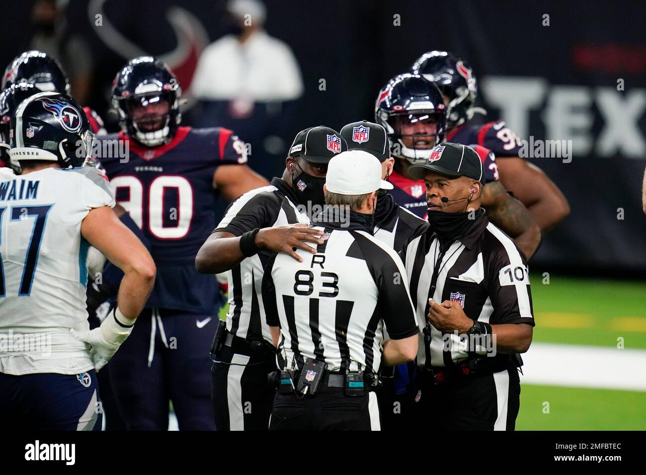 NFL line judge Carl Johnson (101) along with referee Shawn Hochuli (83 ...