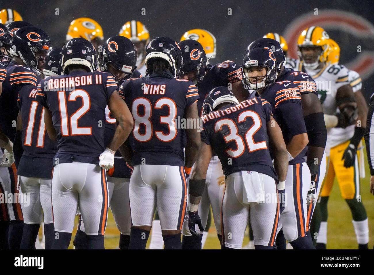 The Chicago Bears huddle during the first half of an NFL football game ...