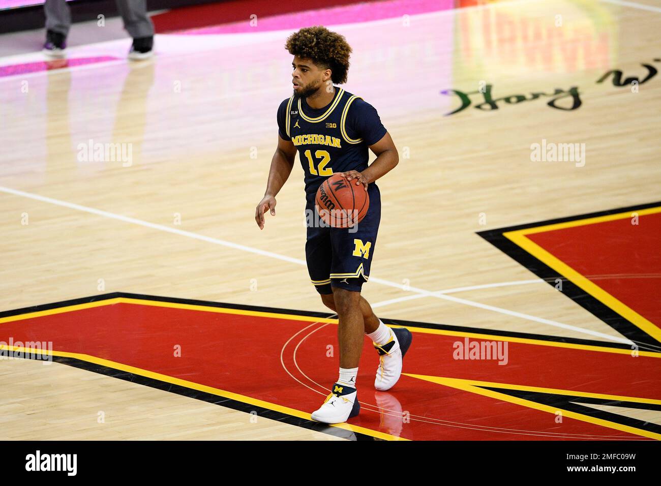 Michigan guard Mike Smith (12) dribbles the ball during the first half ...