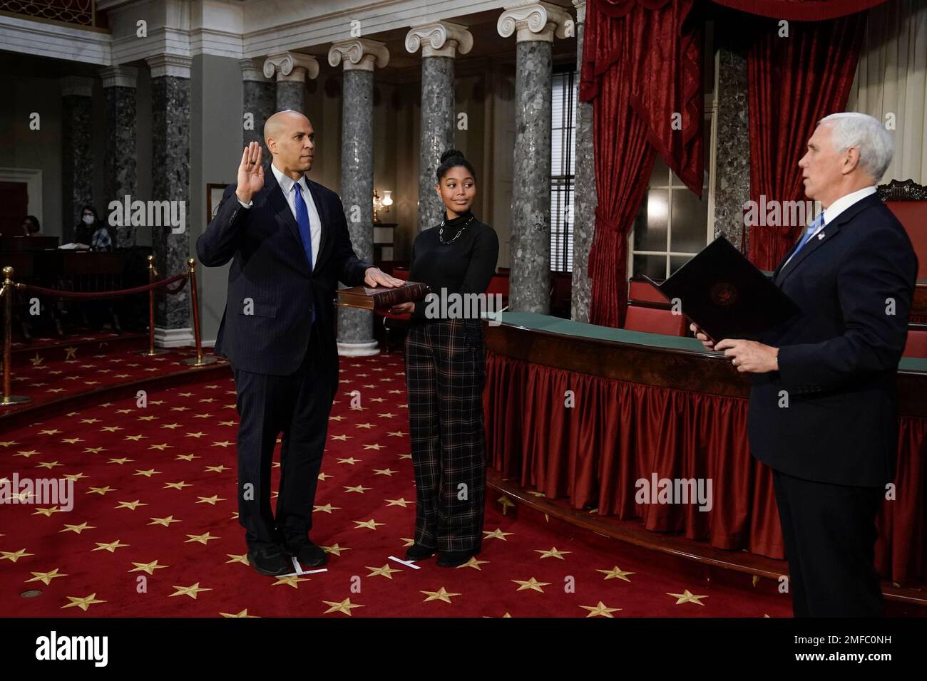 Sen. Cory Booker, D-N.J., joined by his niece Zelah Booker, raises his ...
