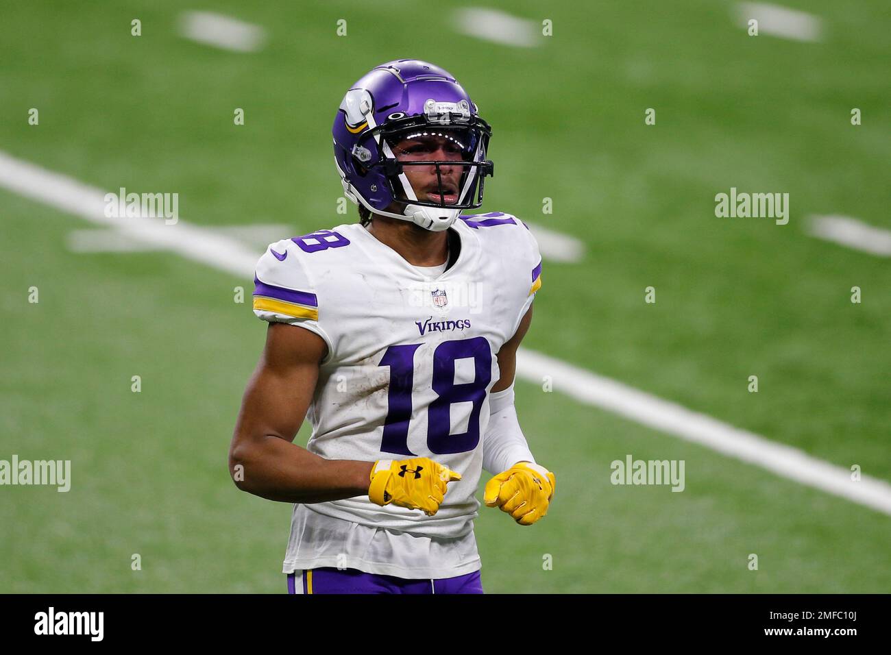 Minnesota Vikings wide receiver Justin Jefferson runs to the bench ...