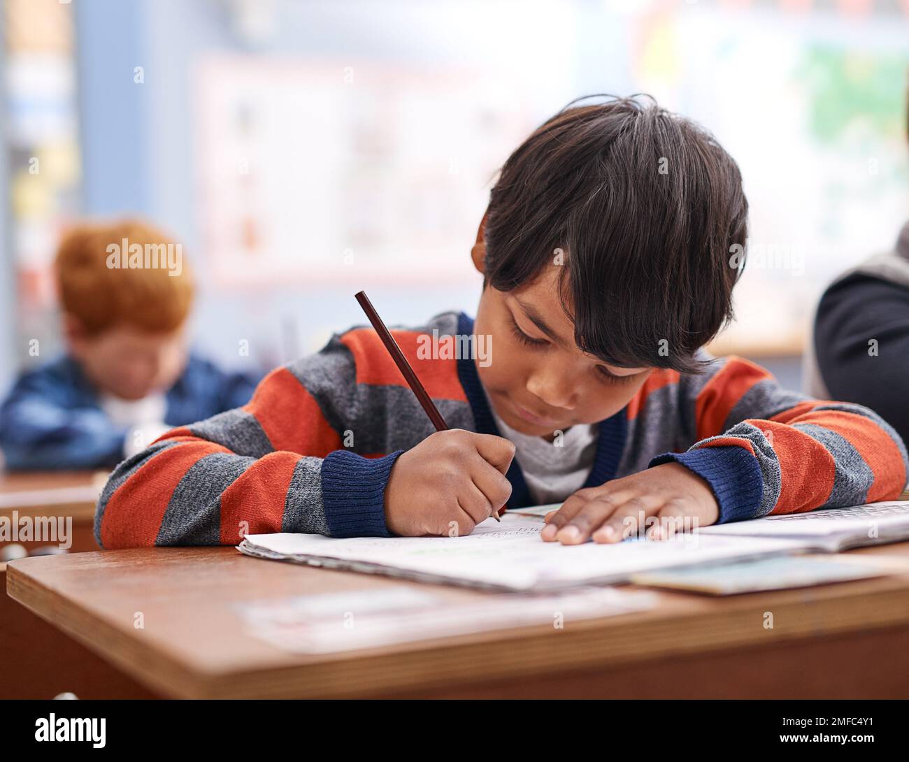 Hes a hard worker even at this age. elementary school children in class ...