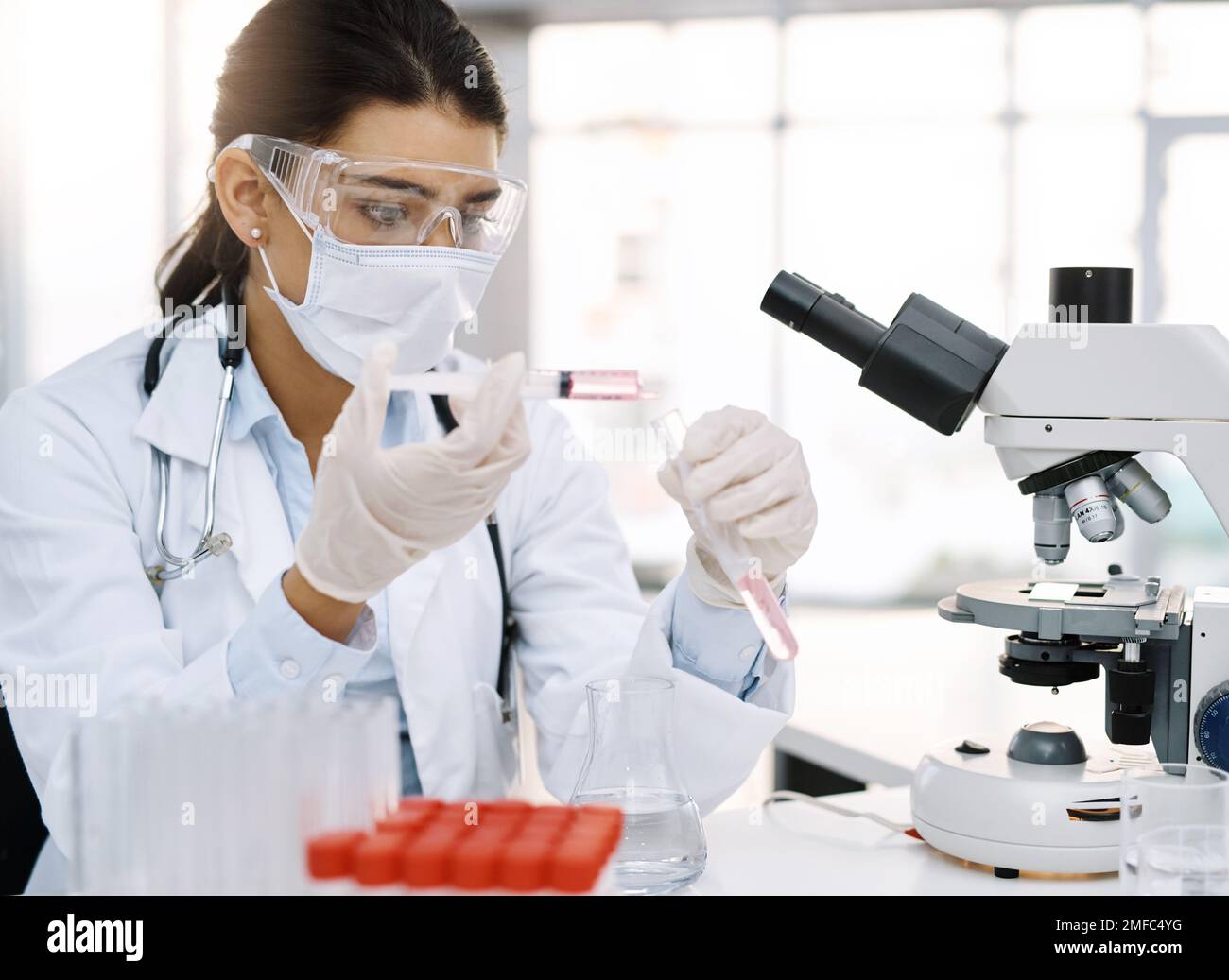Lets see how these react. a young scientist working in a lab Stock Photo - Alamy