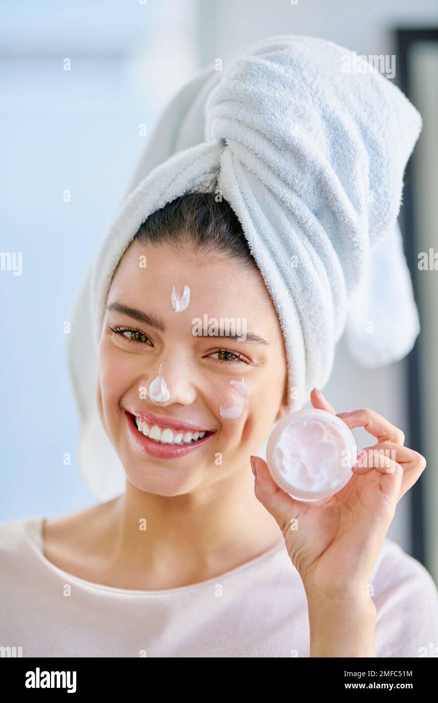 This is my skincare secret. a beautiful young woman grooming herself at ...