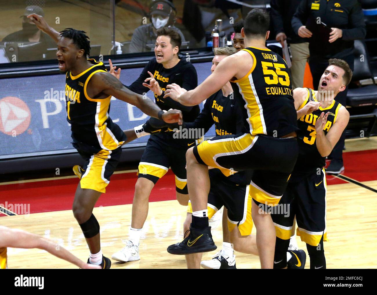 Iowa celebrates after defeating Rutgers in an NCAA college basketball ...