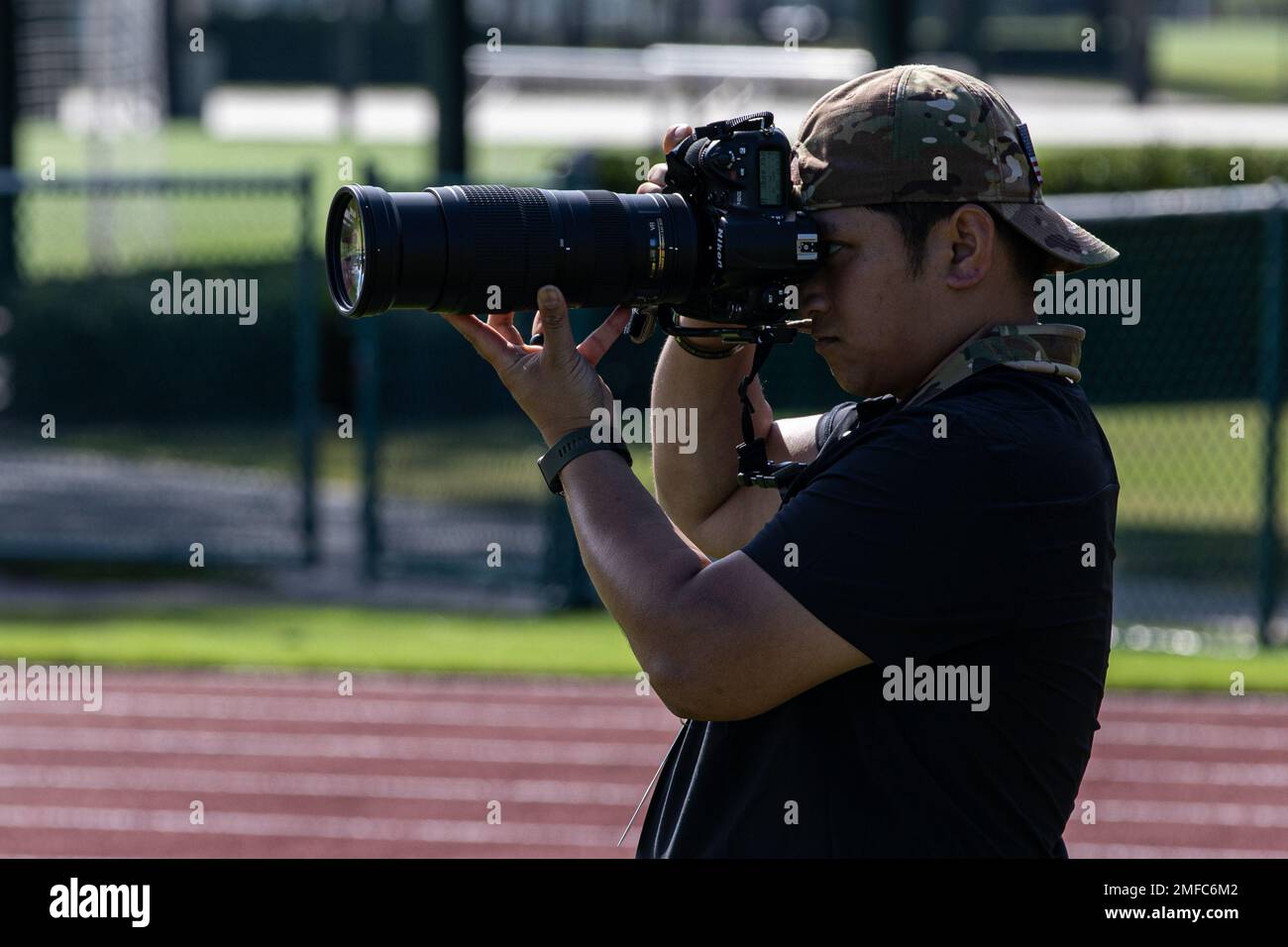 U.S. Army Sgt. Henry Villarama takes photos of a Team Army track and ...