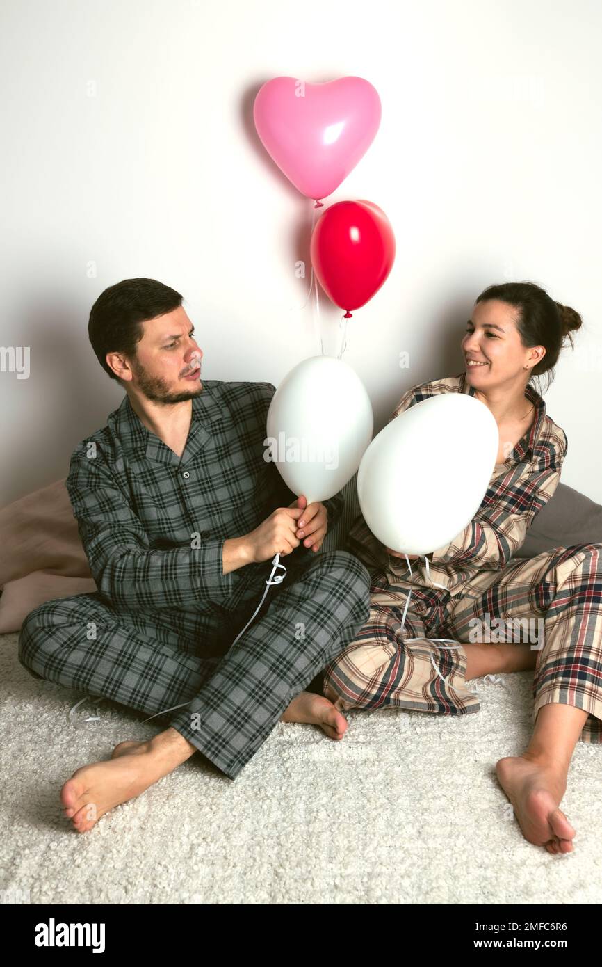 Couple of lovers holds balloons in the shape of a heart. The concept of ...