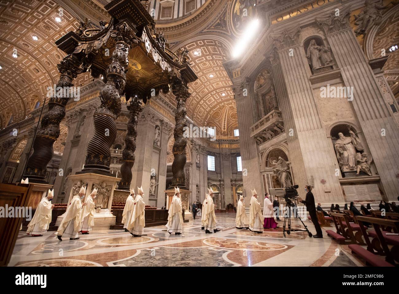 Clergy arrive in procession to attend a new year Mass in St. Peter's ...