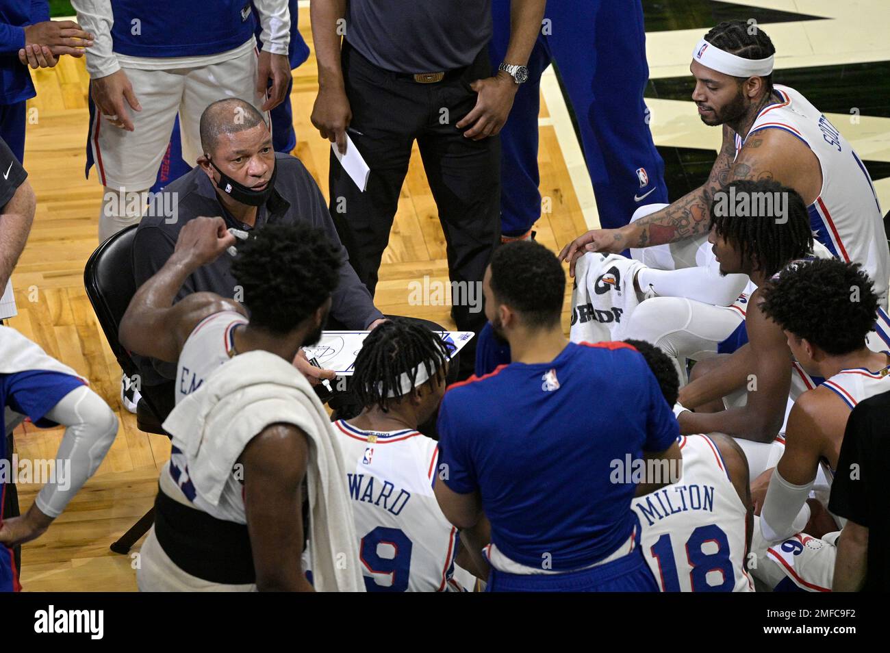 Philadelphia 76ers head coach Doc Rivers, left, talks to his players in ...