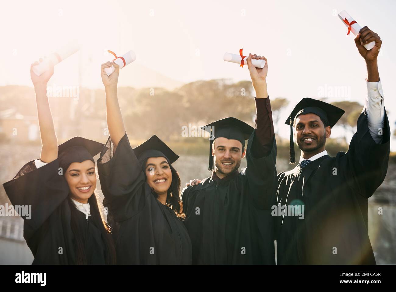 Holding up the key to their successful future. Portrait of a group of ...
