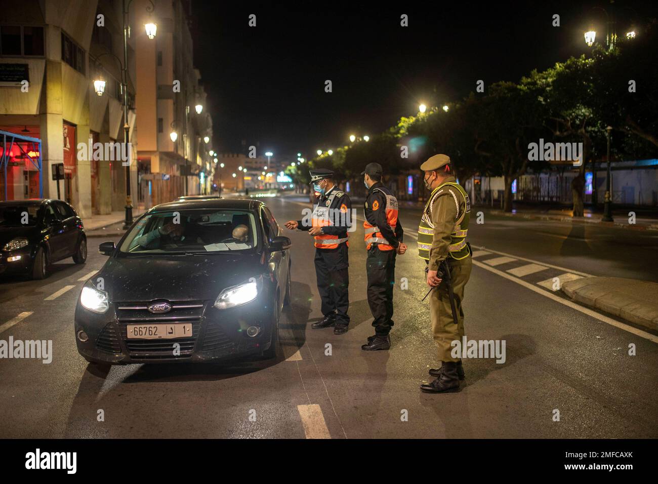 Security forces enforce a curfew on New Year's Eve to prevent ...