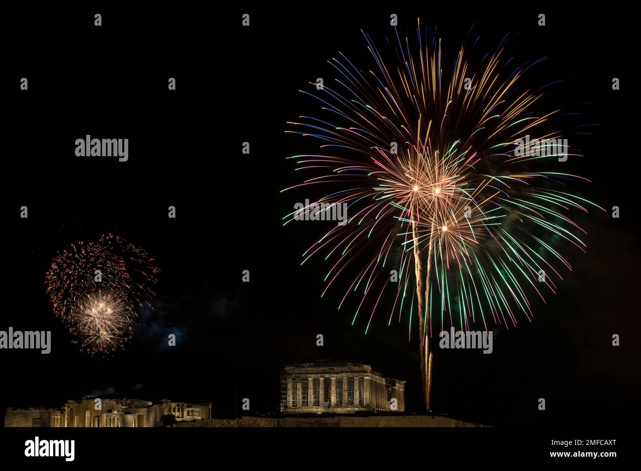 Fireworks explode over the ancient Acropolis hill with the Parthenon ...