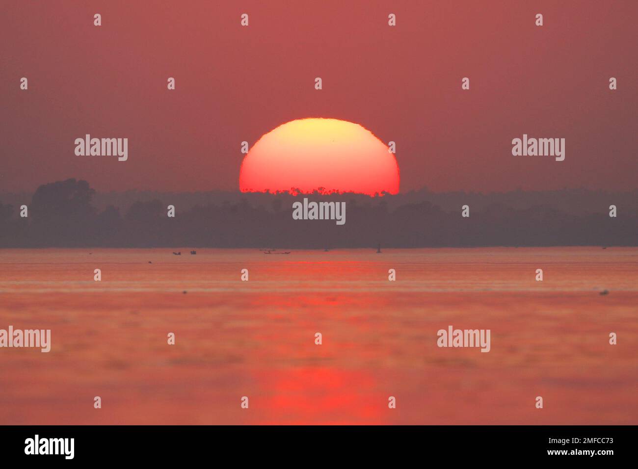 The sun sets over the Irrawaddy River near Mandalay, Myanmar, on New ...