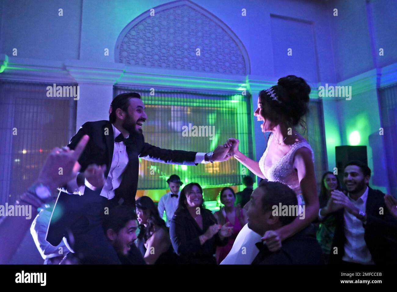 Israeli couple Noemie Azerad, right, and her husband Simon David ...