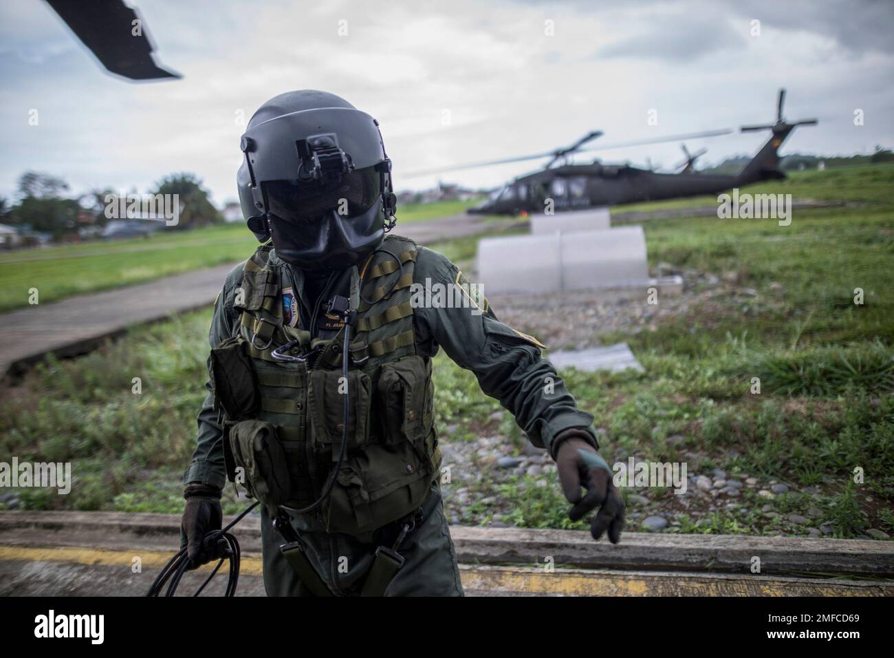 The gunman of a Colombian police helicopter prepares to take off for a ...