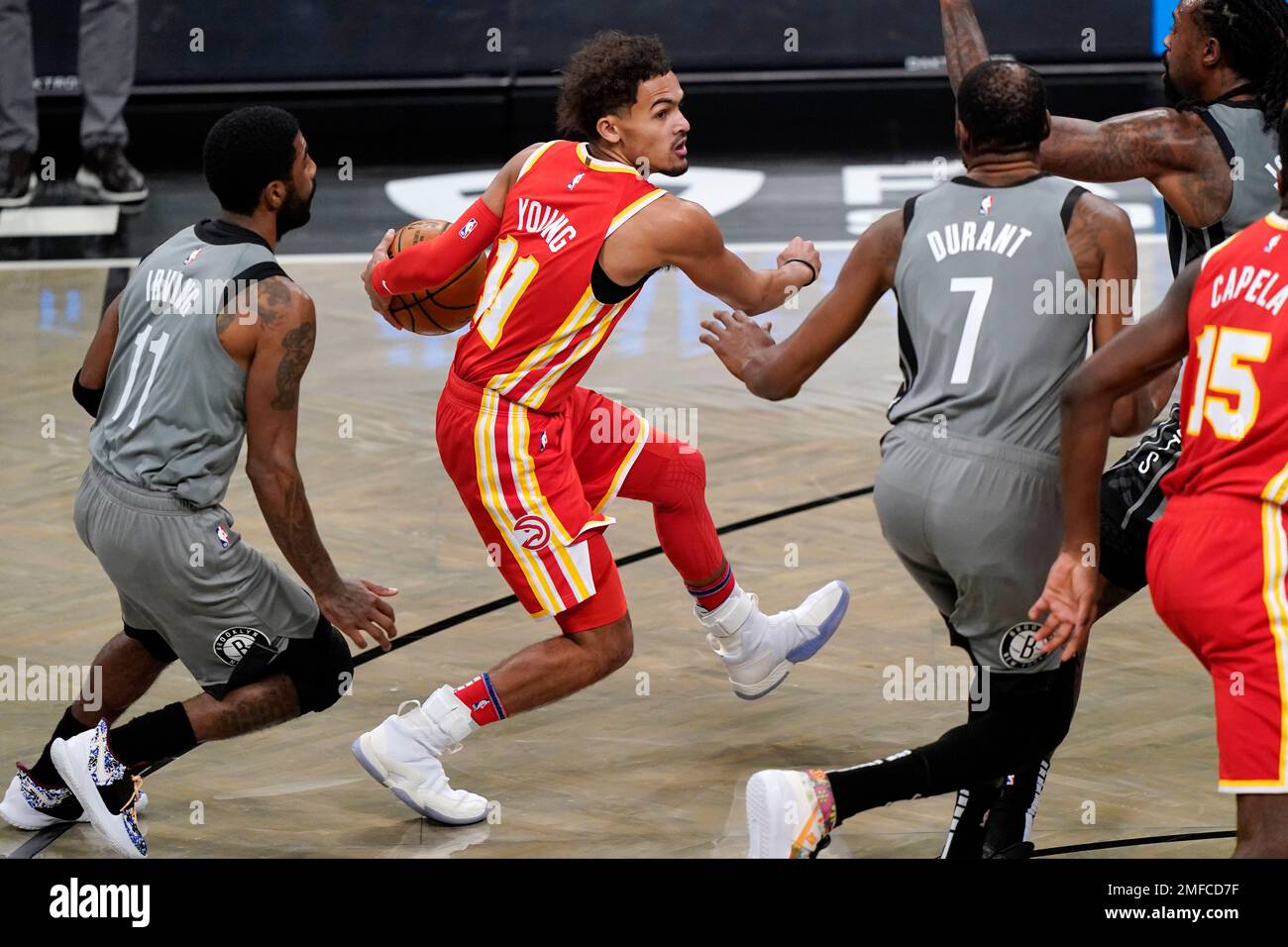 Atlanta Hawks guard Trae Young (11) moves between Brooklyn Nets guard ...