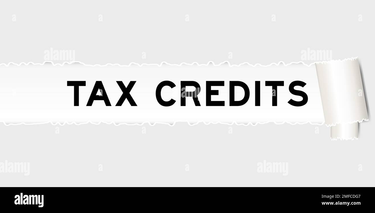 Ripped gray paper background that have word tax credits under torn part ...