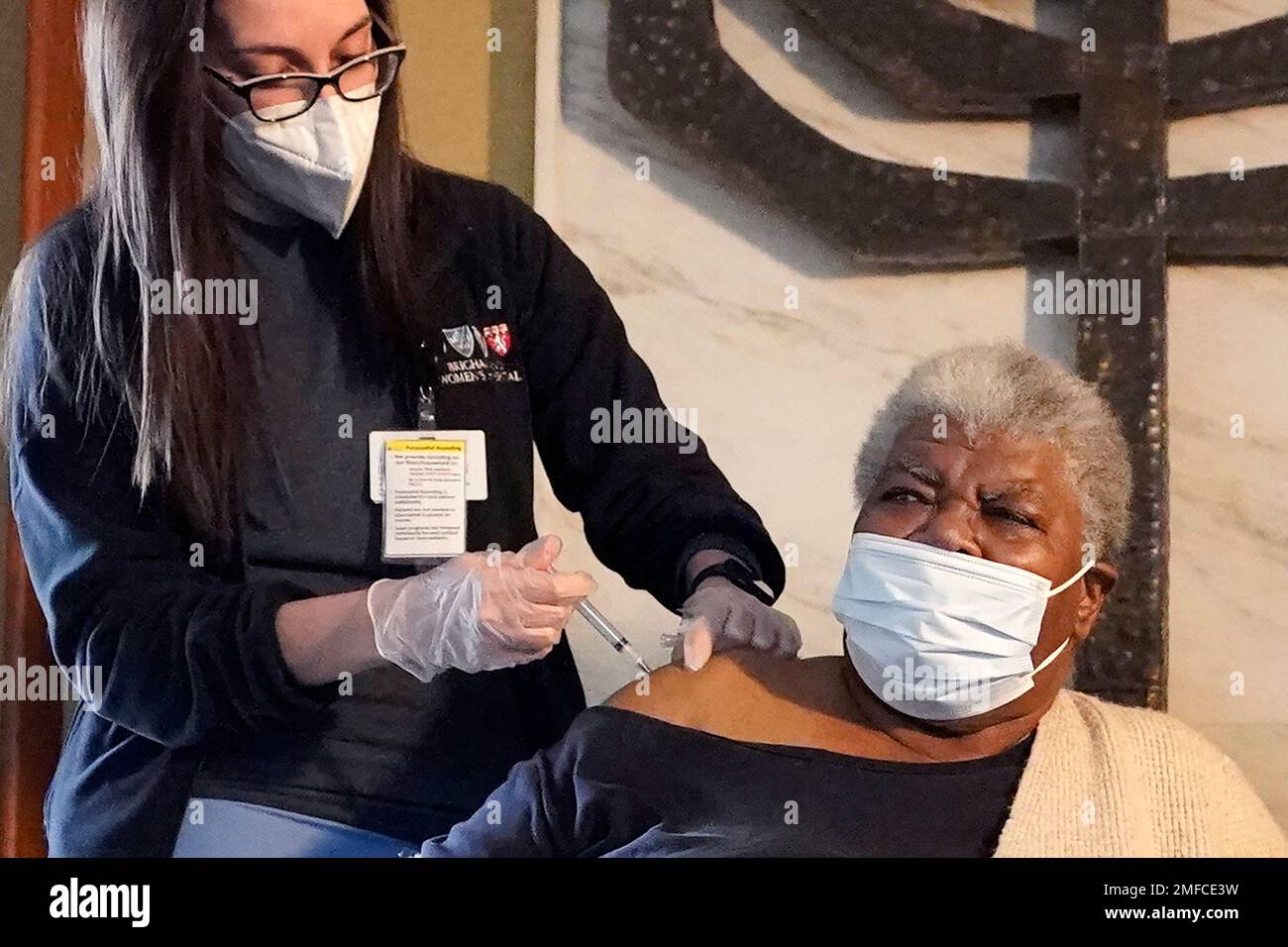 Nurse Lisa Lopes administers a COVID-19 vaccine to Patricia Marson, the ...