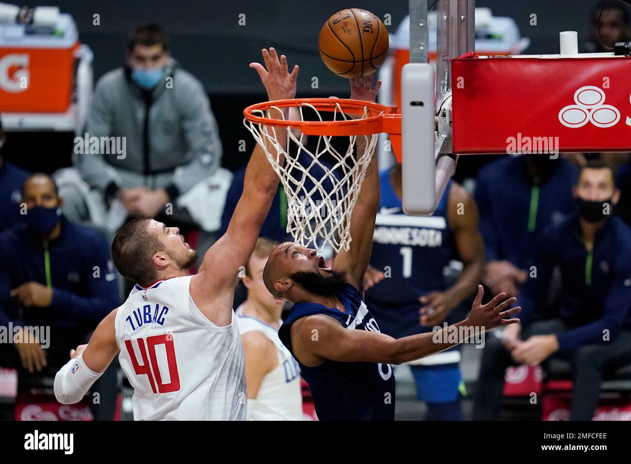 Minnesota Timberwolves guard Jordan McLaughlin, right, shoots next to ...