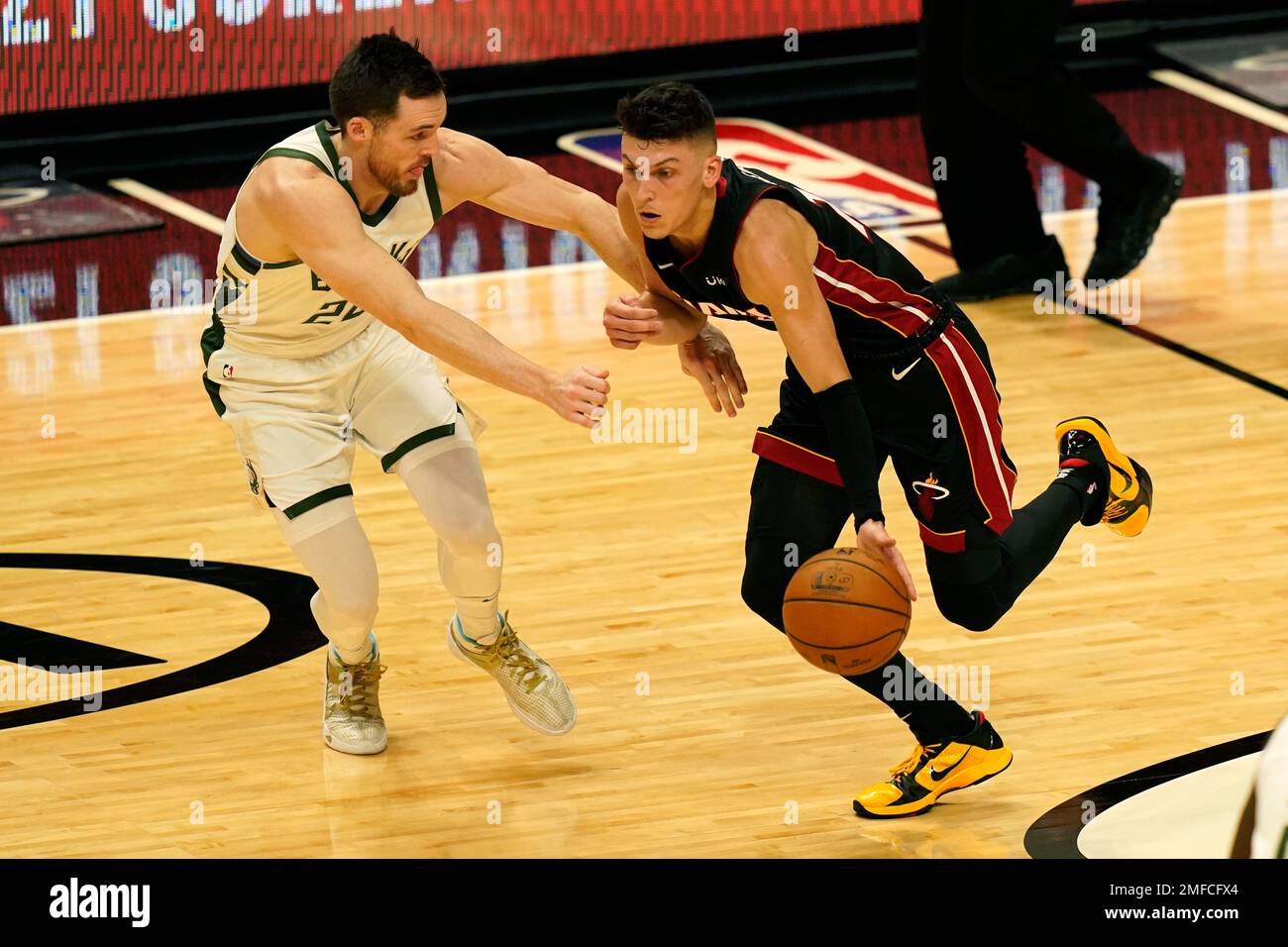 Miami Heat guard Tyler Herro, right, is defended by Milwaukee Bucks ...