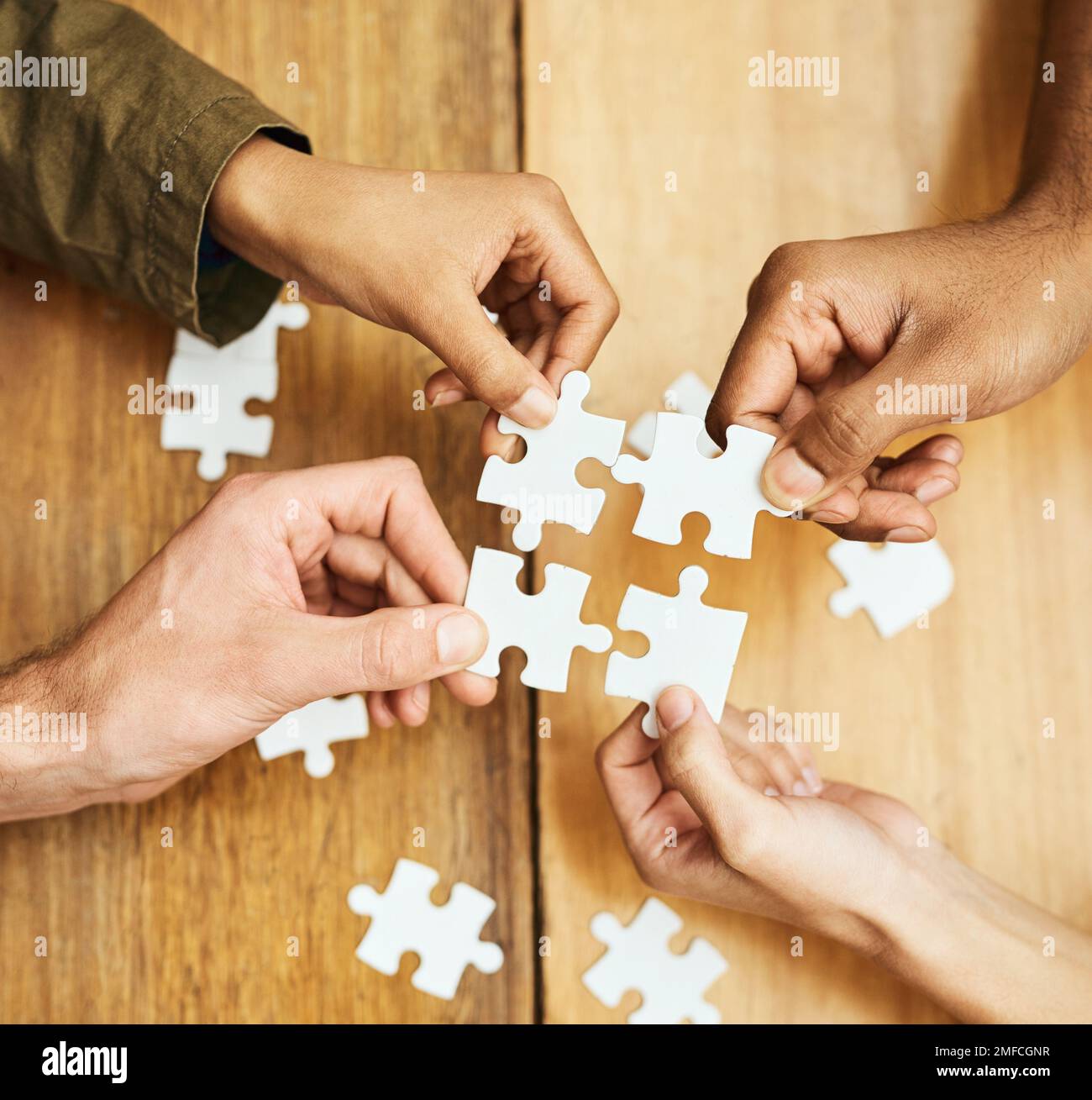 Putting the pieces together. High angle shot of a group of unrecognizable university students ...