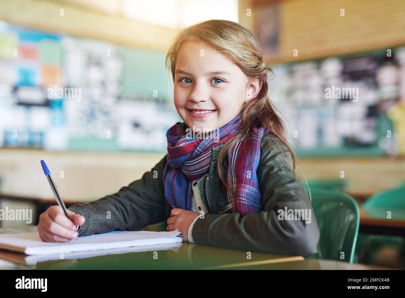 You can see shes ready to write the test. an adorable little girl doing ...