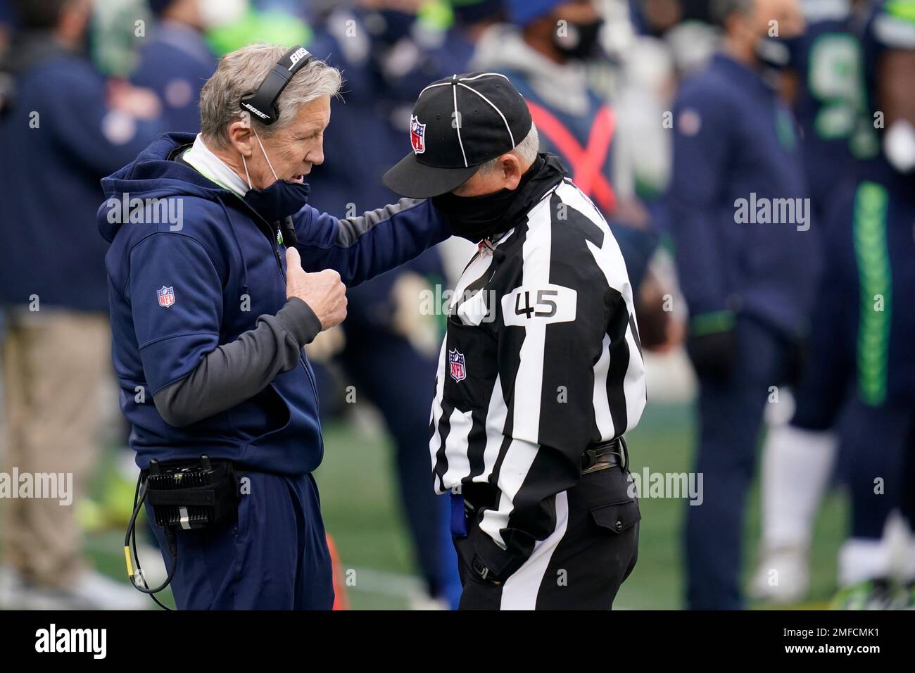 Seattle Seahawks head coach Pete Carroll talks with line judge Jeff ...