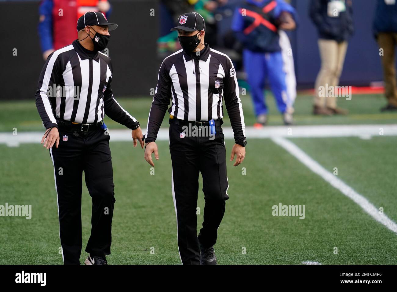 Officials talk during the first half of an NFL football game between ...
