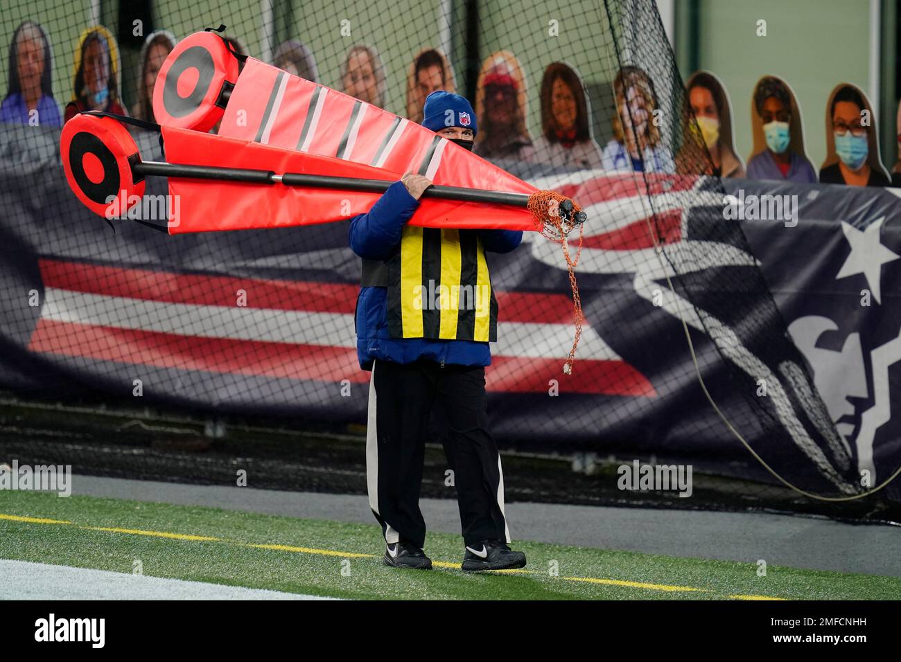 An official carries down marking chains before an NFL football game ...