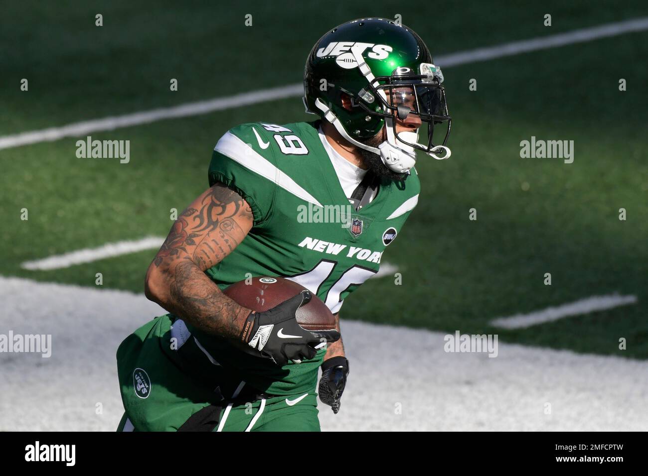 New York Jets' J.T. Hassell warms up before an NFL football game ...