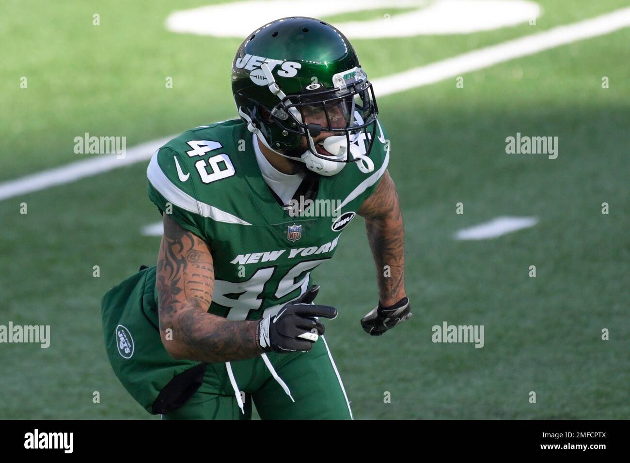 New York Jets' J.T. Hassell warms up before an NFL football game ...
