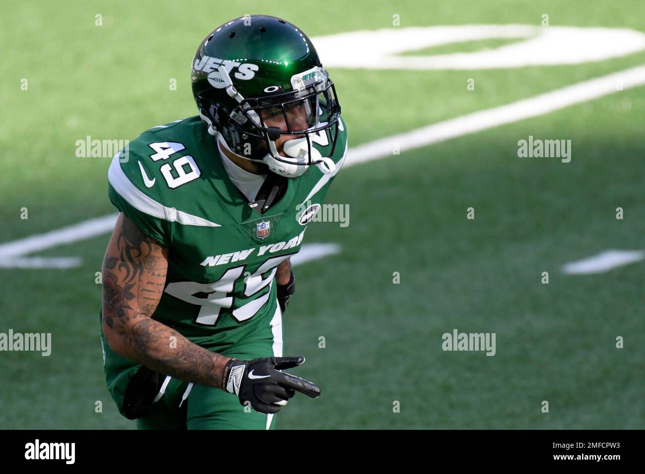 New York Jets' J.T. Hassell warms up before an NFL football game ...