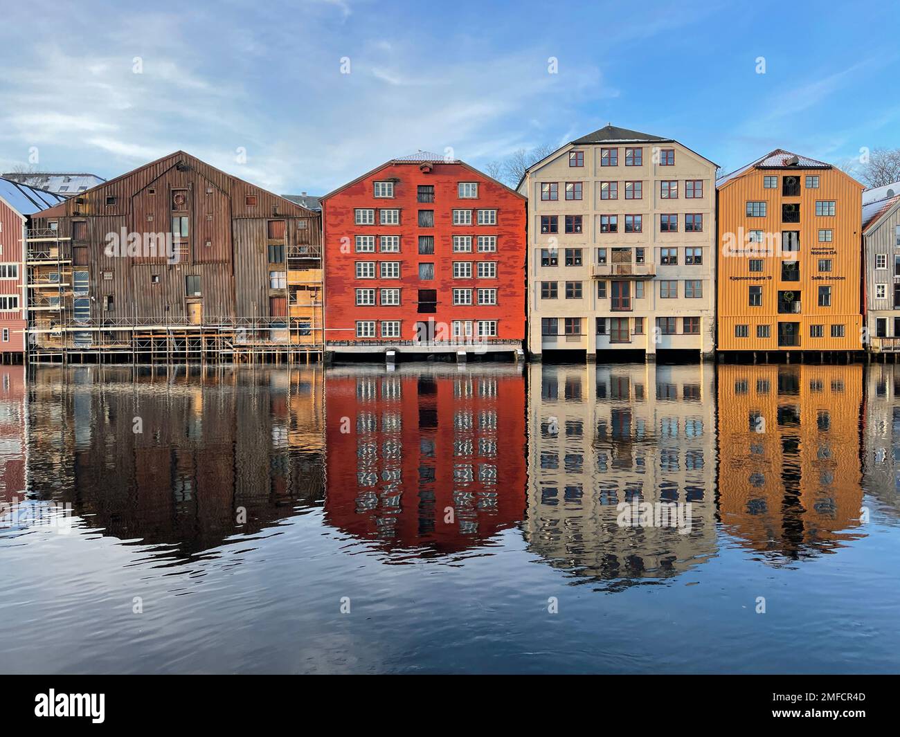 The reflection of the colorful waterfront buildings on a tranquil canal ...