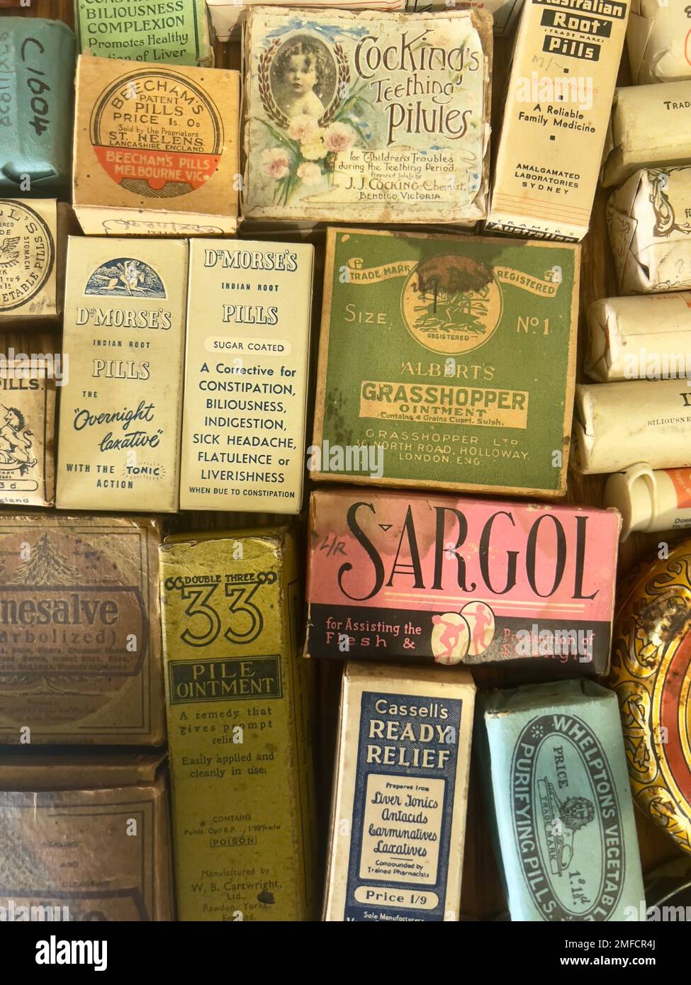 A vertical of vintage packets of medical drugs in colored boxes packed ...