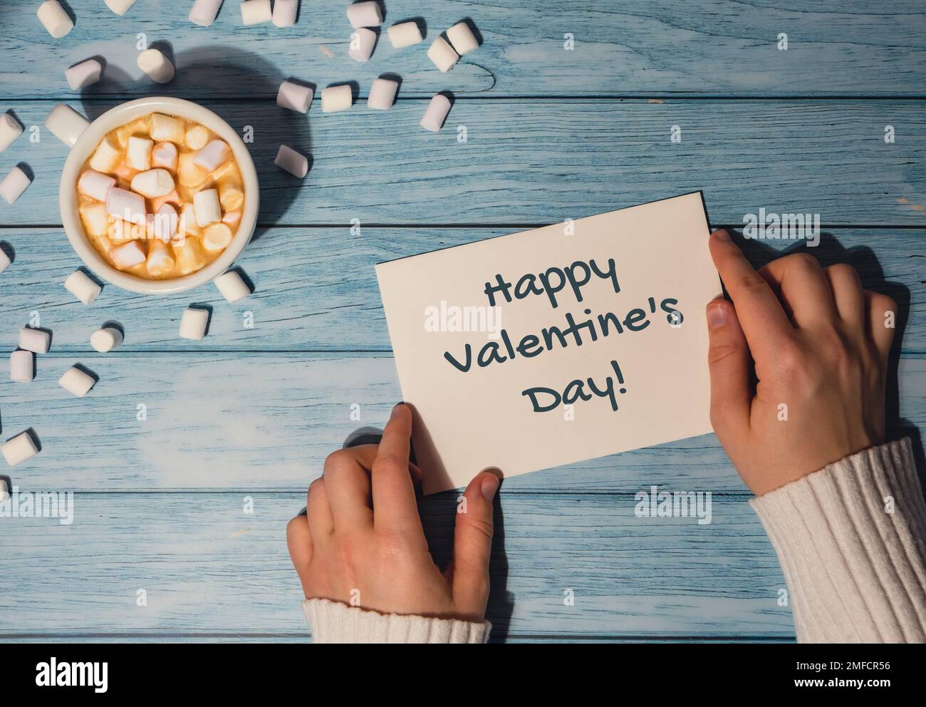 HAPPY VALENTINES DAY text Female hands holding greeting card with white ...