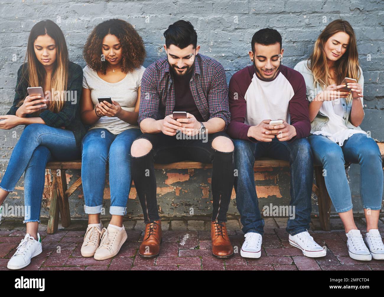 Its all about connectedness these days. a group of young friends using ...