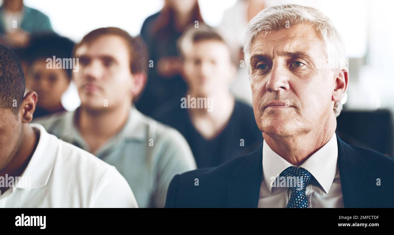 Giving their full attention. a group of corporate businesspeople ...