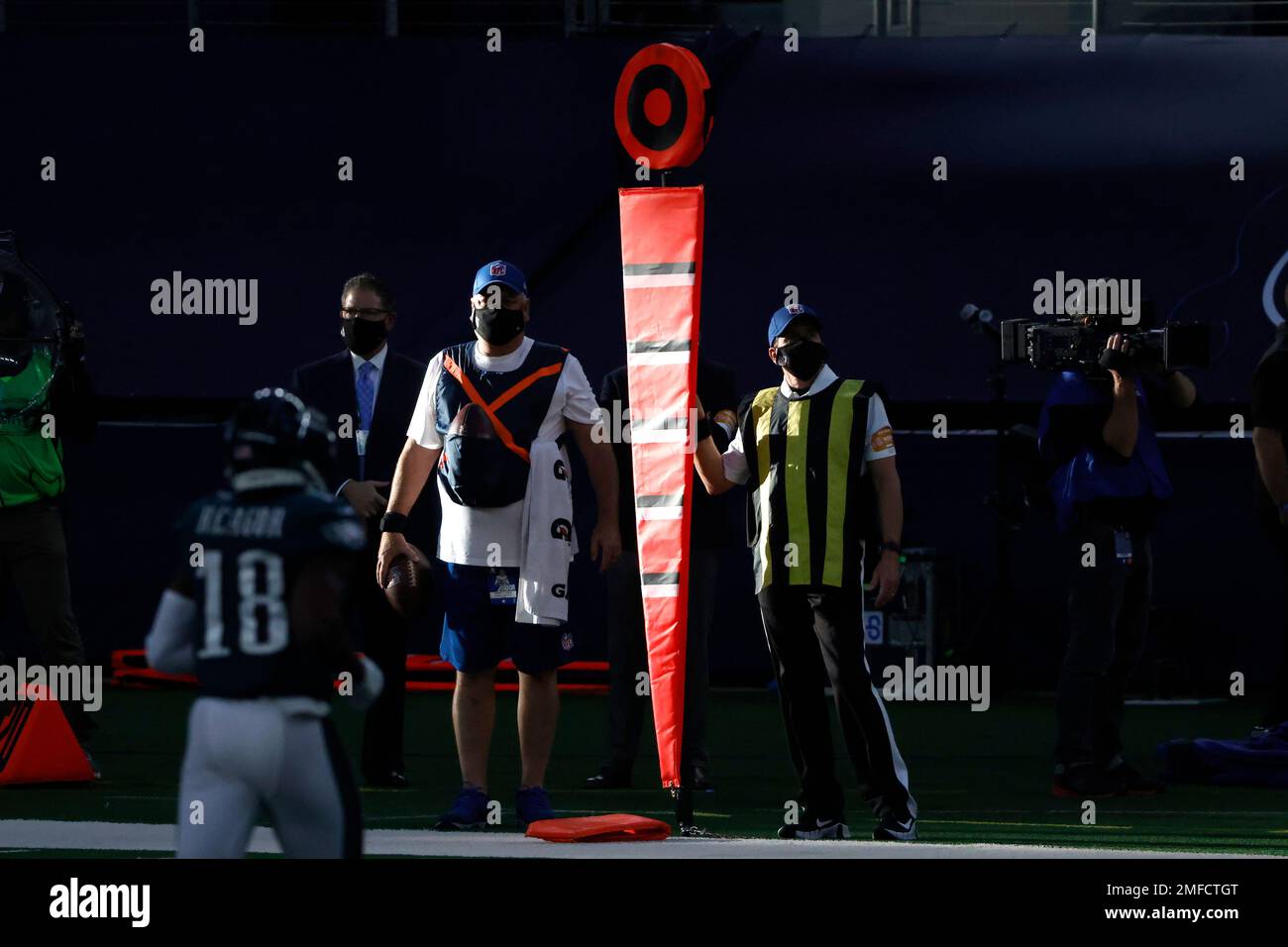 Members of the chain crew work on the sidelines during the game between ...