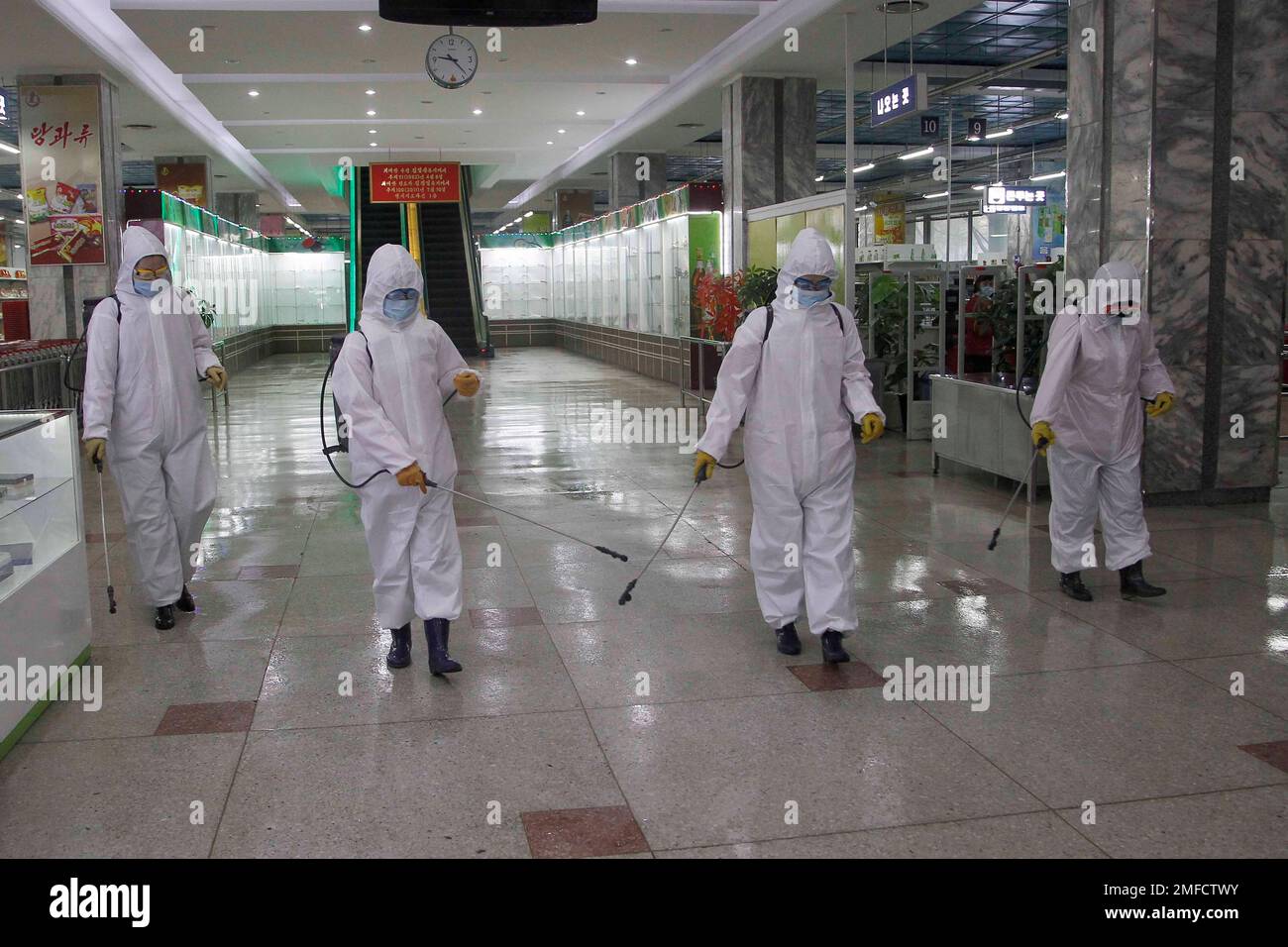 Staff of the Pyongyang Department Store No. 1 disinfect the store ...
