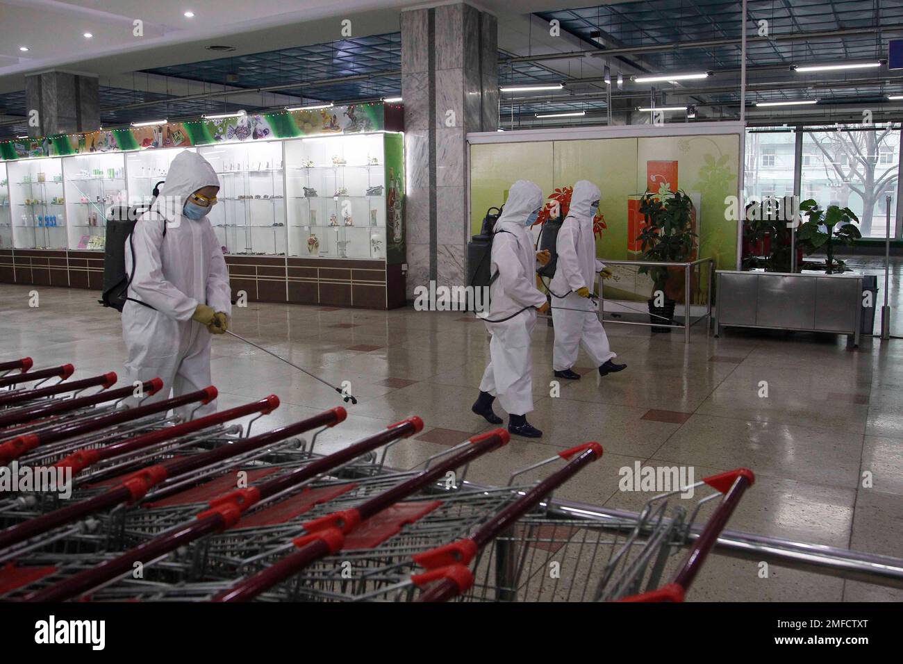 Staff of the Pyongyang Department Store No. 1 disinfect the store ...