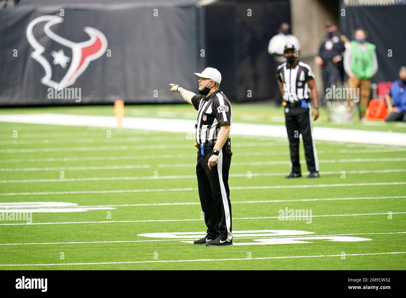 NFL referee Brad Rogers (126) signals during an NFL football game ...