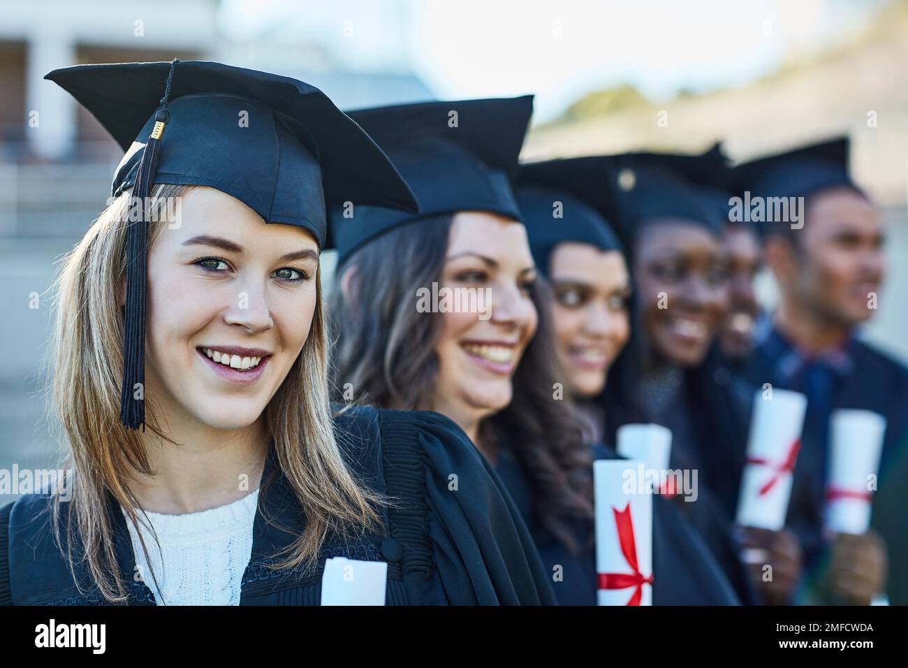 Its a huge accomplishment. Portrait of a group of students standing in ...