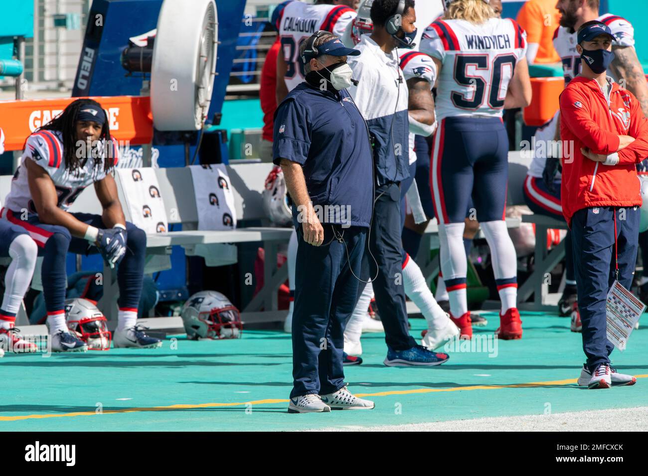 New England Patriots Head Coach Bill Belichick wears a mask on the ...