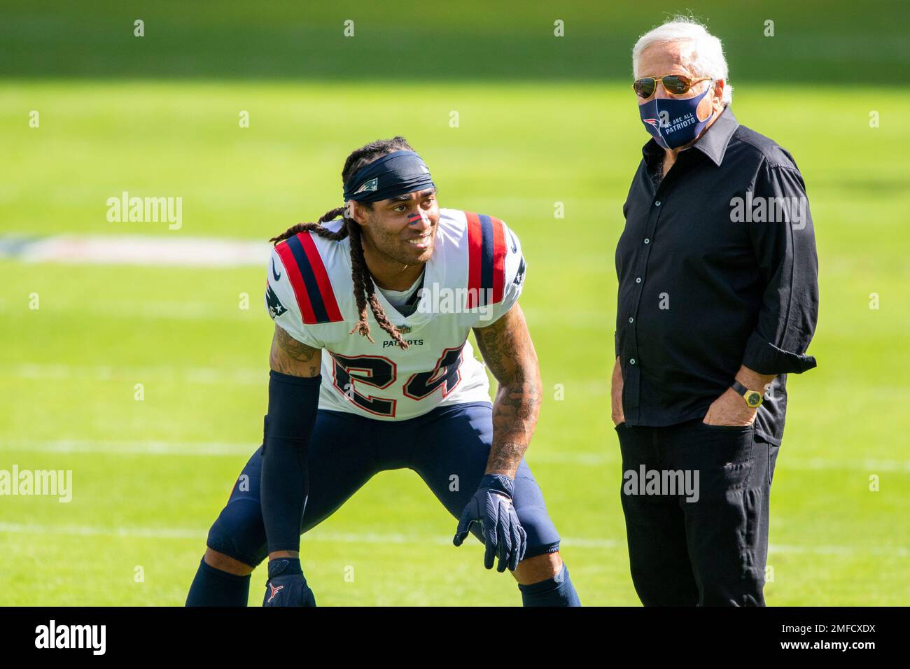 New England Patriots owner Robert Kraft wears a mask on the field as he ...