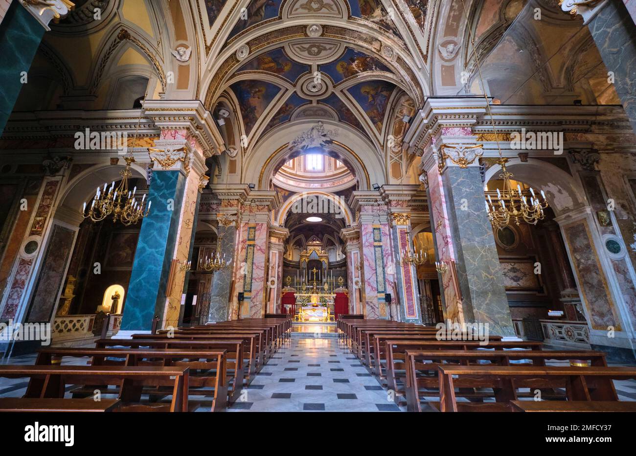 Interior view of the central nave, aisle with wood pews. At the Church ...