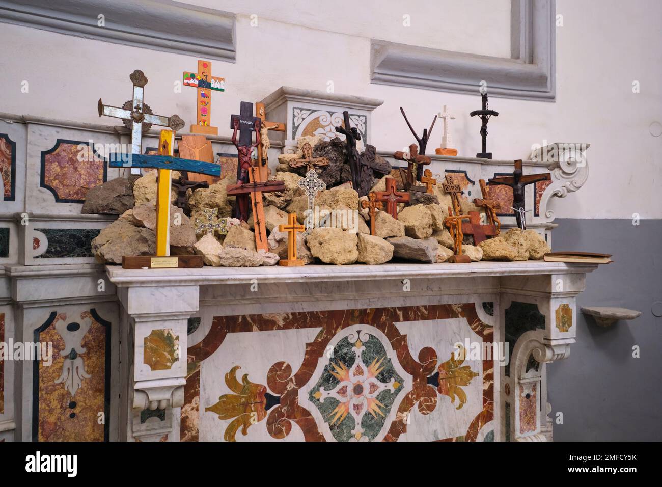 Inside the church, a small, homemade, makeshift shrine of rocks and ...