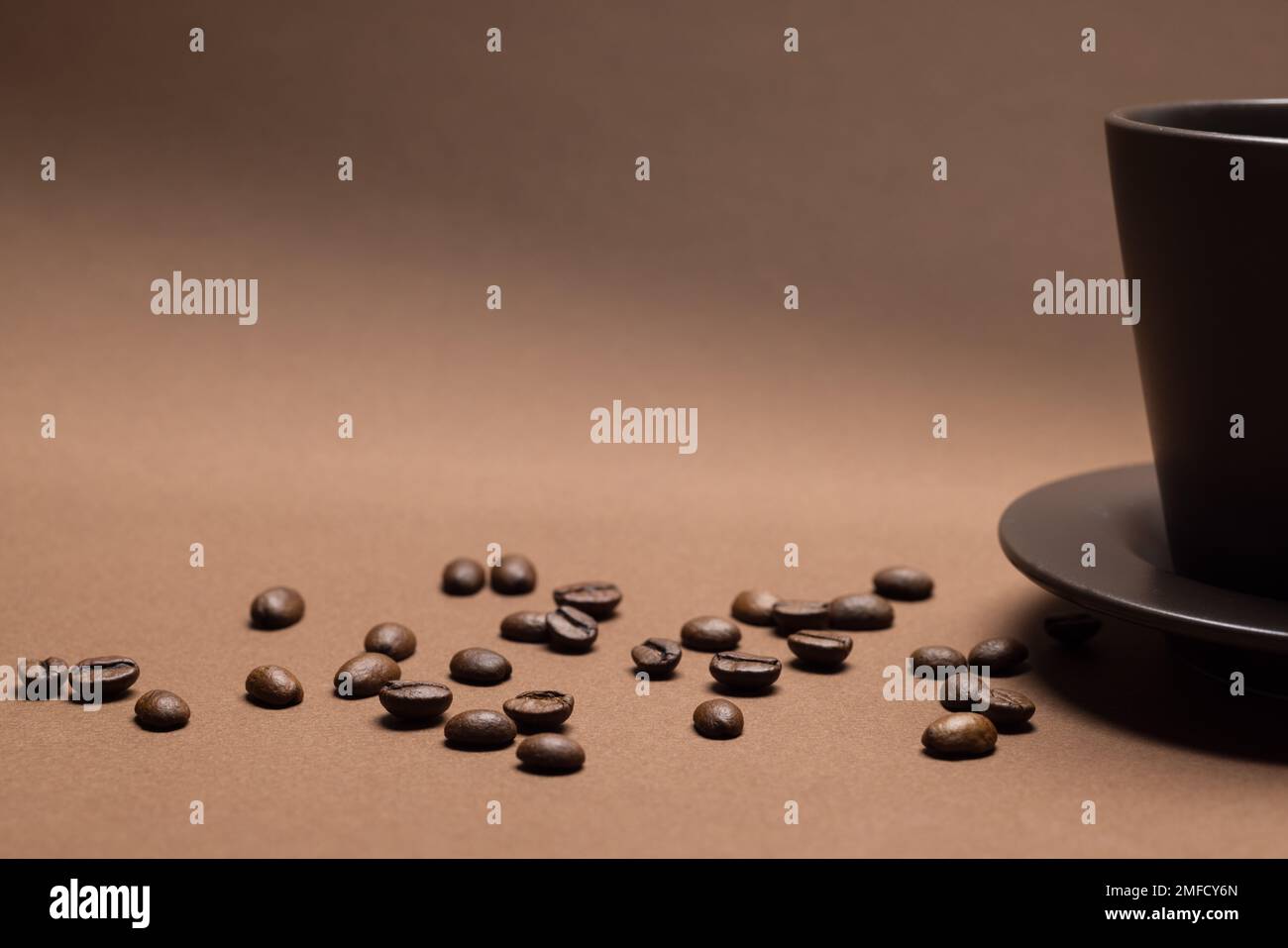 A cup of coffee and coffee beans on the table Stock Photo - Alamy