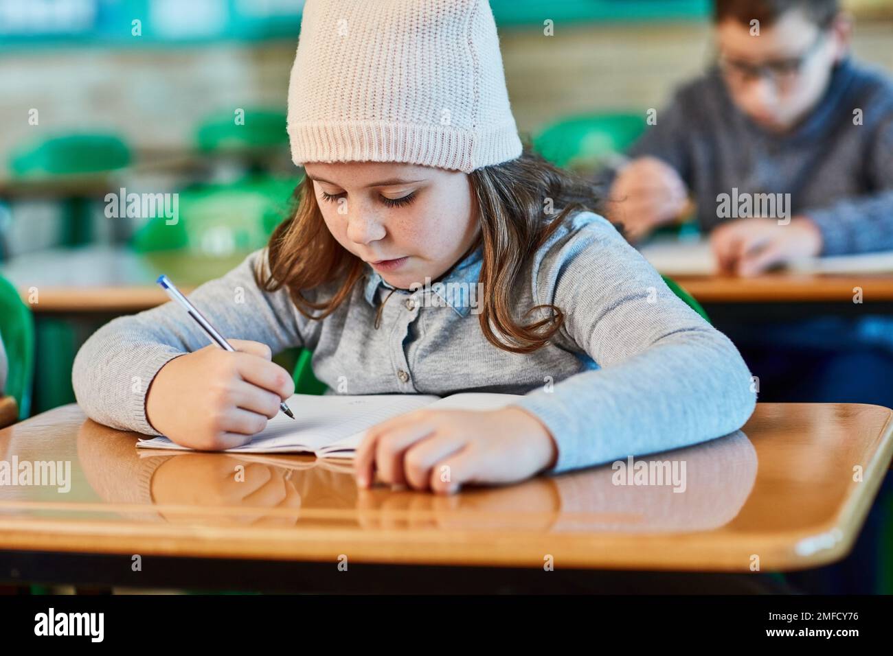 Concentrated on getting her schoolwork done. an elementary school girl ...