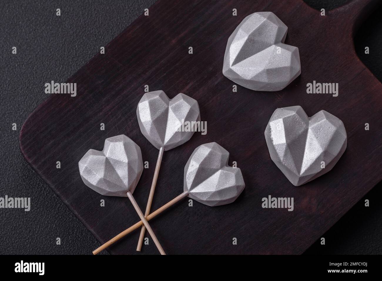 Beautiful tasty sweet candies in gray color on a dark concrete ...