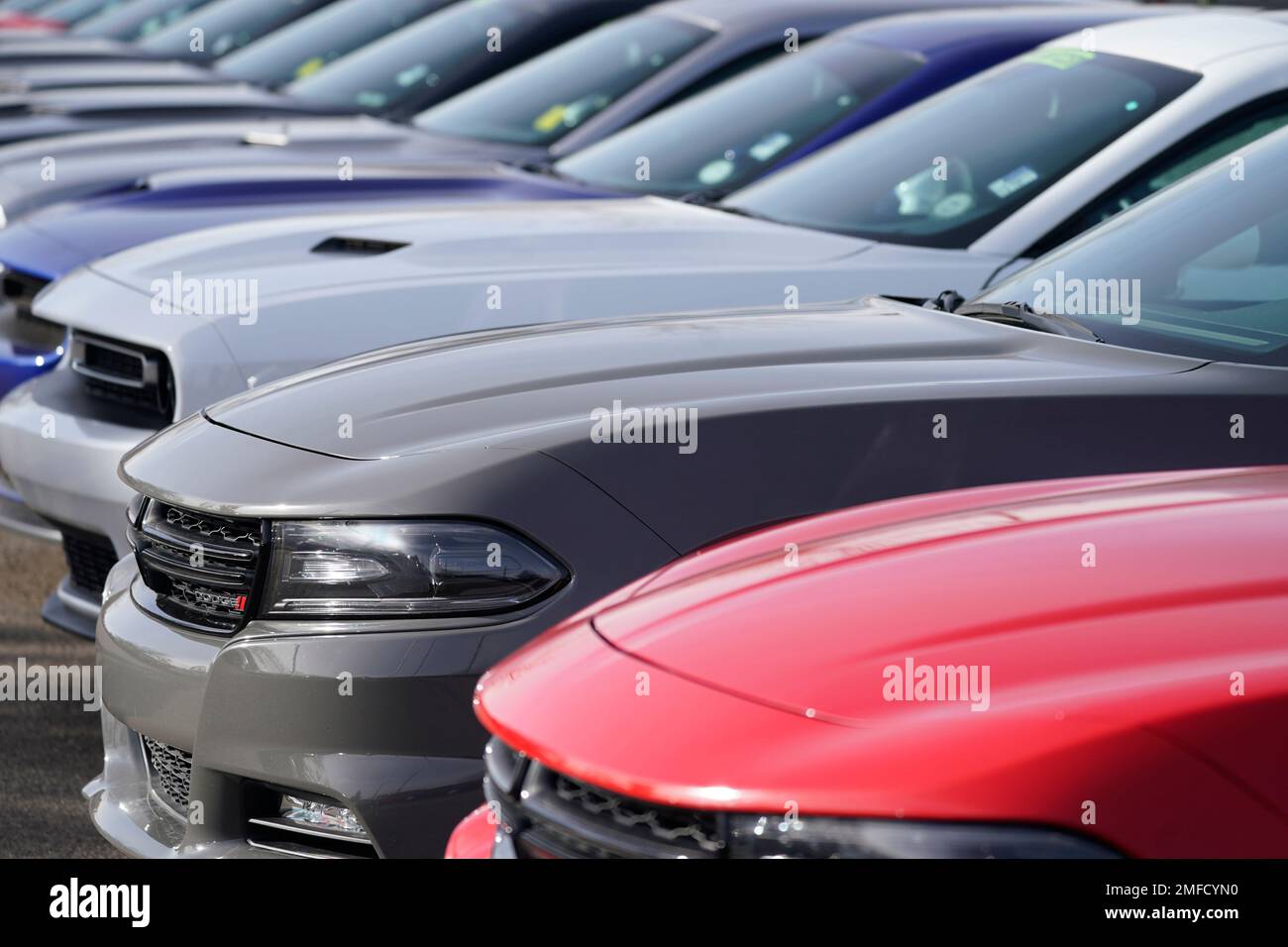 A long row of used Dodge models sits at a Dodge dealership Sunday, Dec ...
